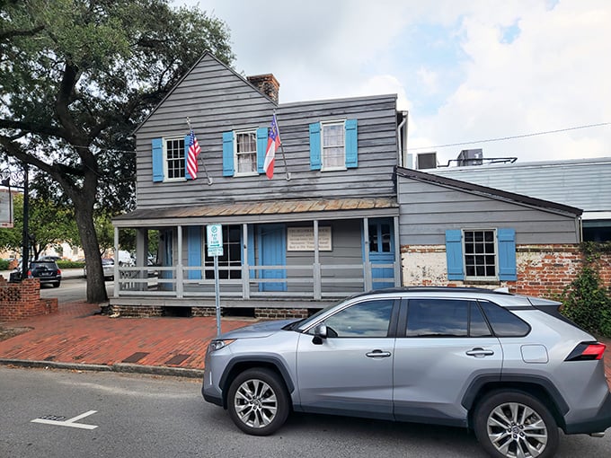 The historic blue-shuttered facade of The Pirates' House stands as a Georgian time capsule, welcoming hungry travelers just as it has since 1753.