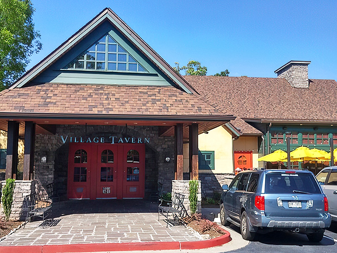 Those iconic red doors might as well have a sign that reads "Prime Rib Pilgrimage Starts Here." The stone façade and peaked roof promise comfort before you even step inside.