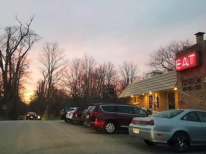 That iconic red "EAT" sign isn't just an invitation – it's a command from the food gods that locals have happily obeyed for generations at this brick-clad treasure.
