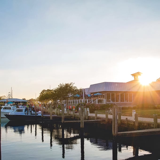 Brew River's weathered gray exterior with vibrant crape myrtle blooms creates the perfect first impression—nature's red carpet welcoming you to Eastern Shore dining excellence.