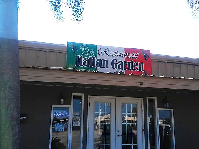 The welcoming facade of Italian Garden beckons hungry travelers with its cheerful signage and cozy entrance. A hidden gem waiting to be discovered.