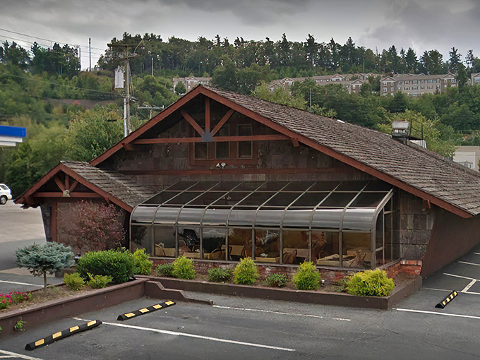 The rustic cabin exterior with its weathered shingles and iconic 1972 entrance doesn't just whisper "come in" – it practically shouts "carnivorous nirvana awaits!"
