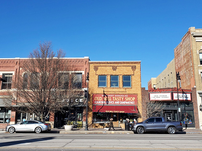 The yellow brick façade and classic red awning of Old Mill Tasty Shop isn't just a storefront—it's a time machine disguised as a downtown Wichita landmark.