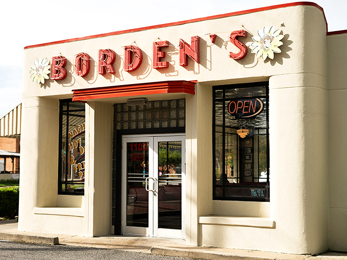 The classic white building with its cheerful red sign isn't just a landmark—it's a time machine disguised as an ice cream parlor.