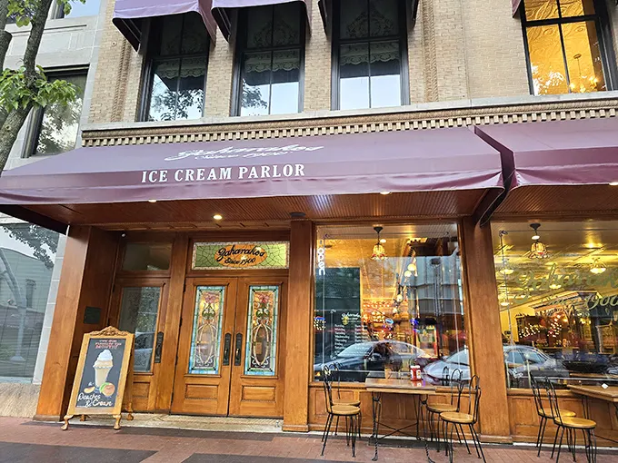 Step back in time with Zaharakos' stunning wooden façade – where the red awnings aren't just decorative, they're practically inviting you in for a sweet escape.