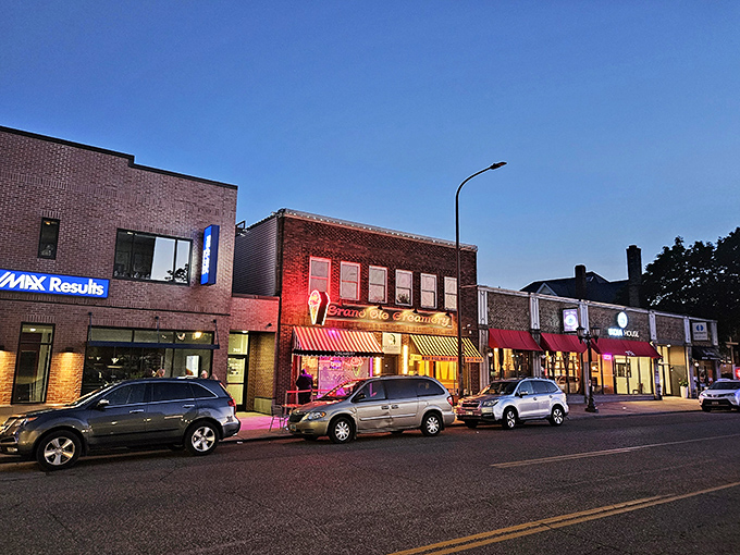 The iconic brick façade of Grand Ole Creamery, with its vintage striped awnings and neon ice cream cone sign, beckons sweet-toothed pilgrims from across Minnesota.