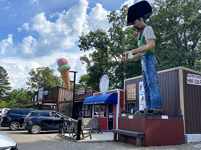 The cowboy statue and giant ice cream cone aren't just landmarks—they're sentinels guarding the gateway to frozen paradise in Broken Bow.