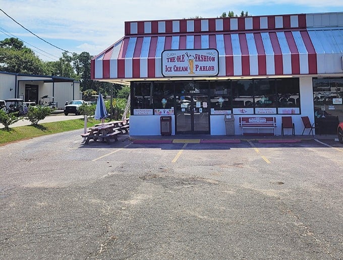 The red and white striped awning isn't just eye-catching—it's the universal signal that serious ice cream happiness awaits inside. No filter needed on this classic Americana.