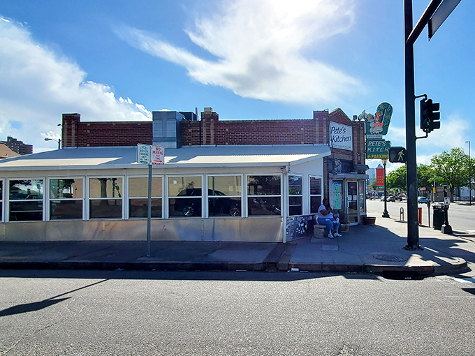 The neon glow of Pete's Kitchen at dusk isn't just a sign—it's a beacon of hope for hungry souls wandering Colfax Avenue.