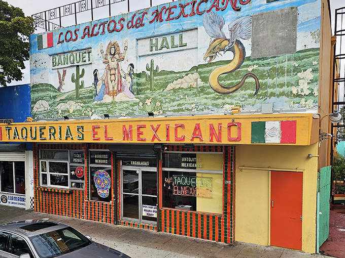 The vibrant mural above Taquerias El Mexicano isn't just decoration—it's a promise of the authentic flavors waiting inside this Little Havana landmark.