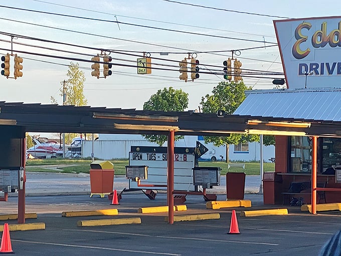 Eddie's iconic orange exterior isn't just a building—it's a time machine disguised as a drive-in, beckoning hungry travelers with its retro charm and promise of burger bliss.