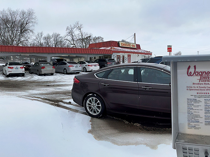 The iconic red-roofed Wagner's Drive-In stands like a time portal to simpler days, beckoning hungry travelers with promises of hand-crafted burgers and nostalgia by the plateful.
