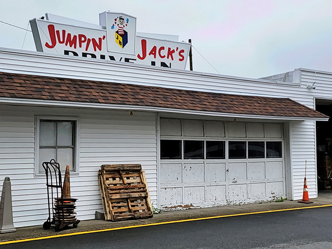 The iconic Jumpin' Jack's sign stands proudly against dramatic skies, while Old Glory waves from a fire truck ladder—a Scotia summer tradition in full swing.