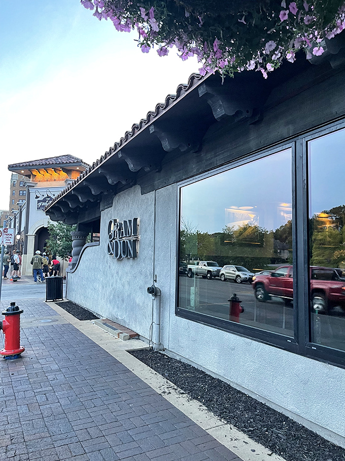 The entrance to Gram & Dun beckons like an old friend with its warm brick façade and elegant signage—architectural foreplay for the culinary adventure that awaits inside.