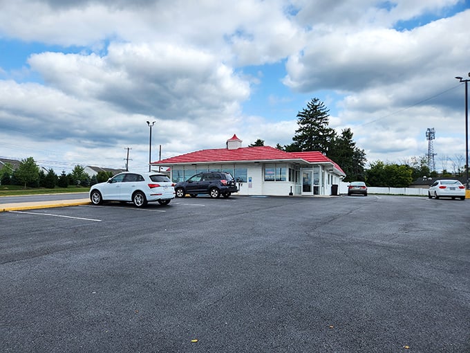 The unassuming white building with its cherry-red roof stands like a beacon of hope for hungry travelers. Culinary treasures often hide in plain sight.