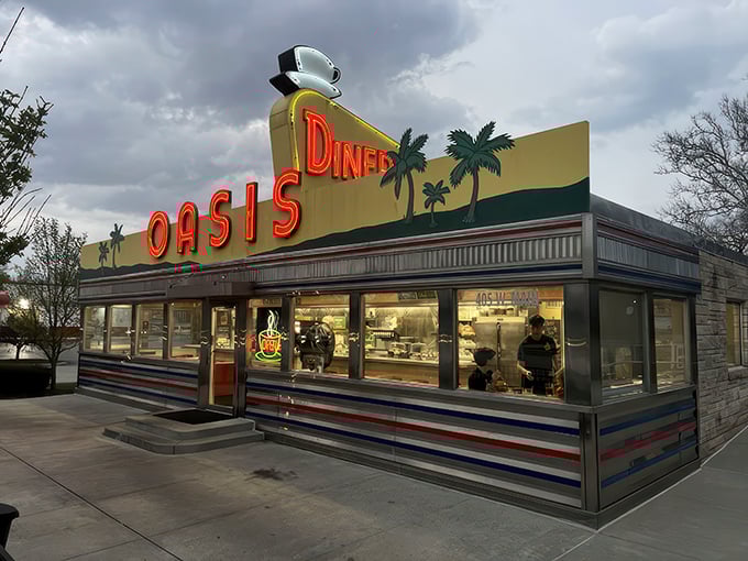 The sunshine-yellow exterior of Oasis Diner beckons like a time portal to the 1950s, complete with palm trees that seem hilariously optimistic in Indiana weather.