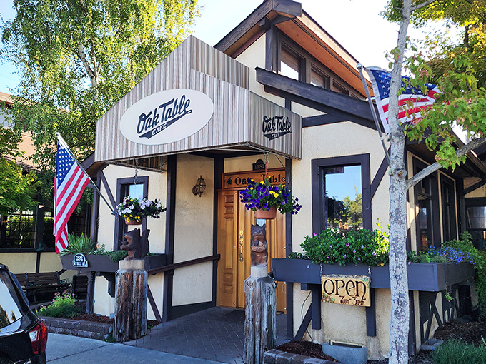 The timber-framed facade of Oak Table Cafe welcomes you like a breakfast hug. Those hanging flower baskets aren't just pretty—they're signaling that good taste awaits inside.