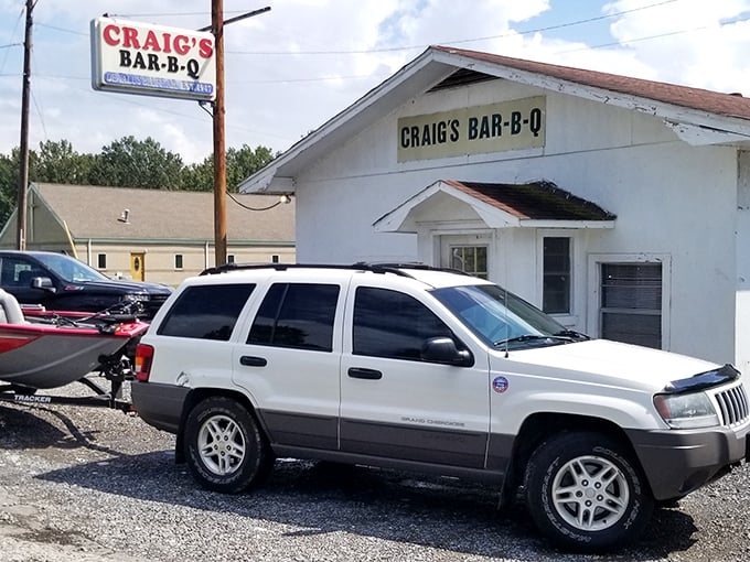 The unassuming white building with its vintage sign promises more than meets the eye. Barbecue pilgrims know: the humbler the exterior, the better the meat inside.