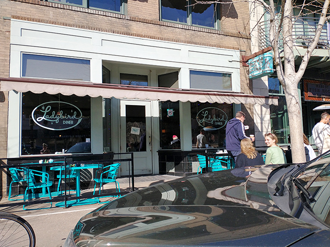 The turquoise chairs outside Ladybird Diner aren't just seating—they're an invitation to slow down and savor life one pancake at a time.