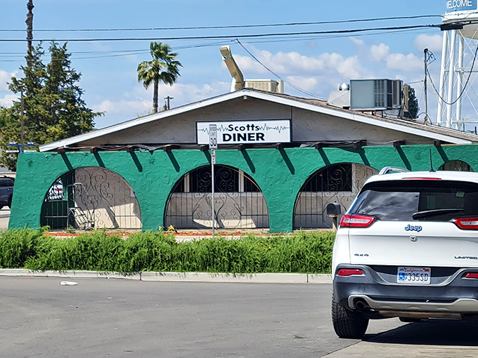 The turquoise exterior of Scotts Diner stands out like a culinary oasis in Merced, beckoning hungry travelers with its charming retro vibe.