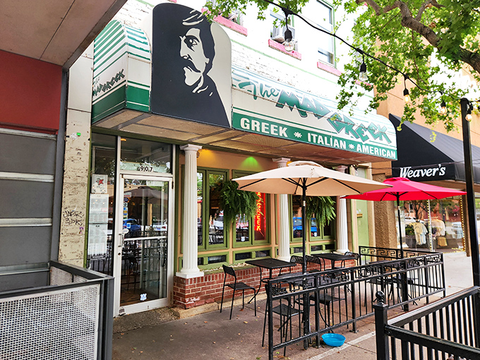 The Mad Greek's inviting storefront beckons with classic white columns and cheerful patio umbrellas—Massachusetts Street's little slice of Athens awaits your discovery.