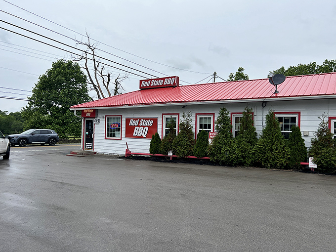 The modest white building with its bright red trim doesn't need fancy architecture—it lets the heavenly aroma of slow-smoked meats do all the talking.