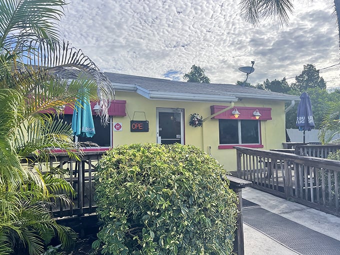 The cheerful yellow exterior with pink awnings isn't just inviting—it's practically shouting "breakfast is served!" Palm trees and a wooden deck complete this slice of Florida comfort.