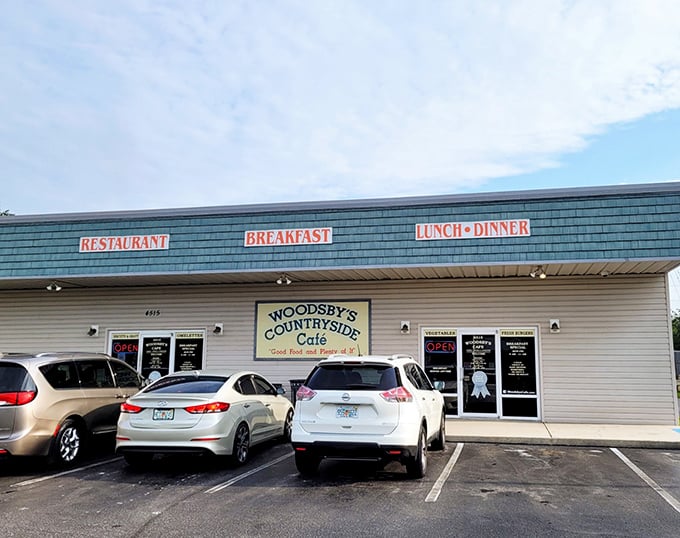 The unassuming exterior of Woodsby's Countryside Cafe stands as a beacon of hope for hungry travelers. No fancy frills, just the promise of honest food inside.
