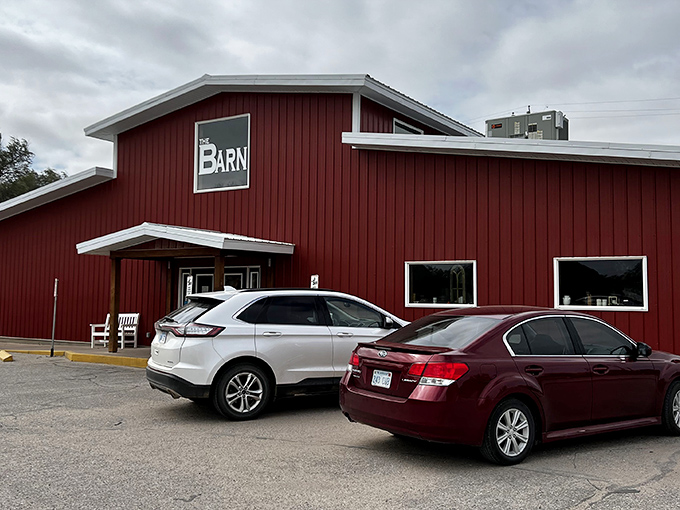 The bright red exterior of The Barn stands out against the Kansas sky like a beacon for hungry travelers. No fancy frills, just the promise of honest-to-goodness comfort food inside.