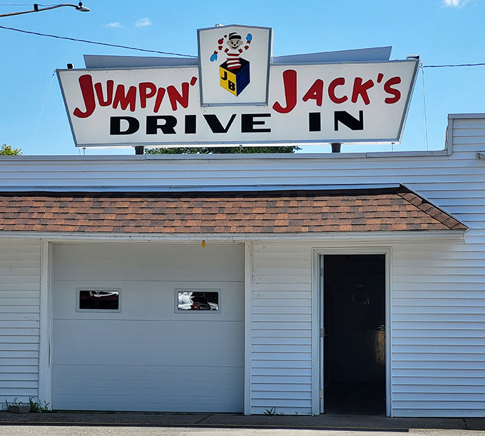 The iconic Jumpin' Jack's sign stands proudly against dramatic skies, while Old Glory waves from a fire truck ladder—a Scotia summer tradition in full swing.