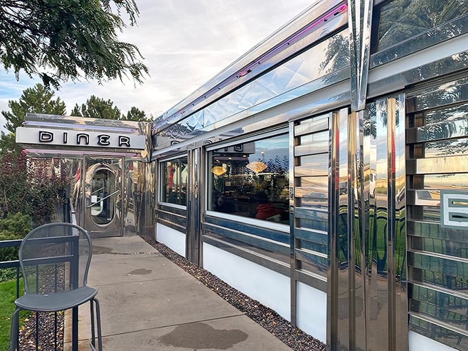 That neon sign doesn't whisper—it announces with retro swagger: "Hungry humans, your comfort food paradise awaits!" The turquoise and red color scheme practically sings against the Colorado sky.