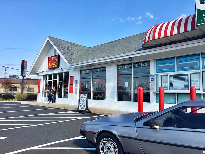 Old School Burgers glows like a beacon at twilight, its colorful mural promising flavor adventures within. The perfect neighborhood joint where memories are made.