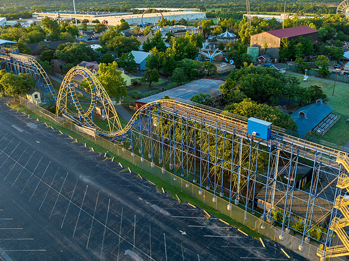 A bird's-eye view reveals Frontier City's wooden roller coaster snaking through lush greenery, proving thrills and nature can coexist beautifully in Oklahoma City.