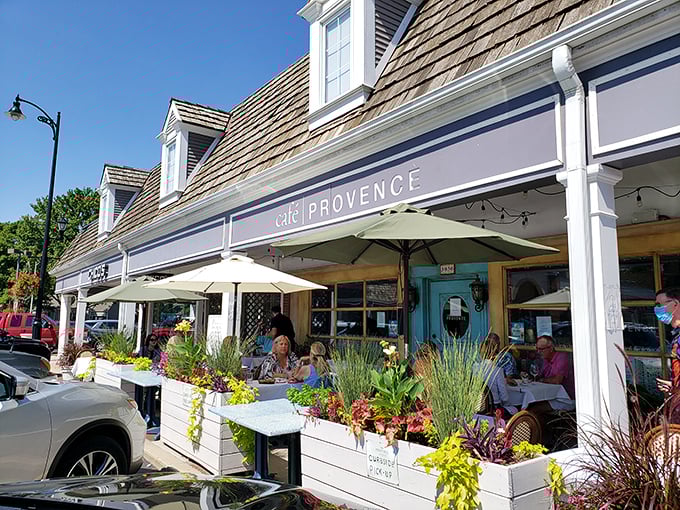 The charming façade of Café Provence beckons with its blue awning and lush planters—a slice of Southern France hiding in plain sight in Prairie Village.