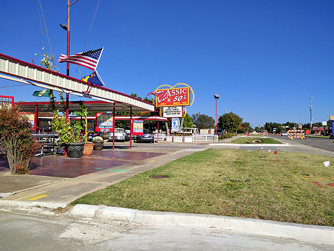 That iconic neon sign isn't just advertising – it's a time machine promising juicy burgers and nostalgia served in equal portions.