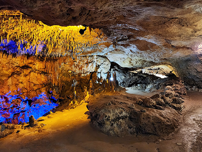 The cave's vibrant lighting transforms ancient limestone into nature's own psychedelic light show. Mother Nature's been decorating for millions of years, and it shows.