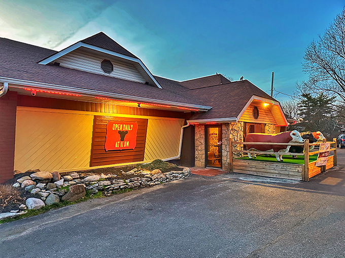 Those cow statues aren't just decoration—they're greeters, bouncers, and a promise of what awaits inside Bynum's rustic stone-and-wood exterior.