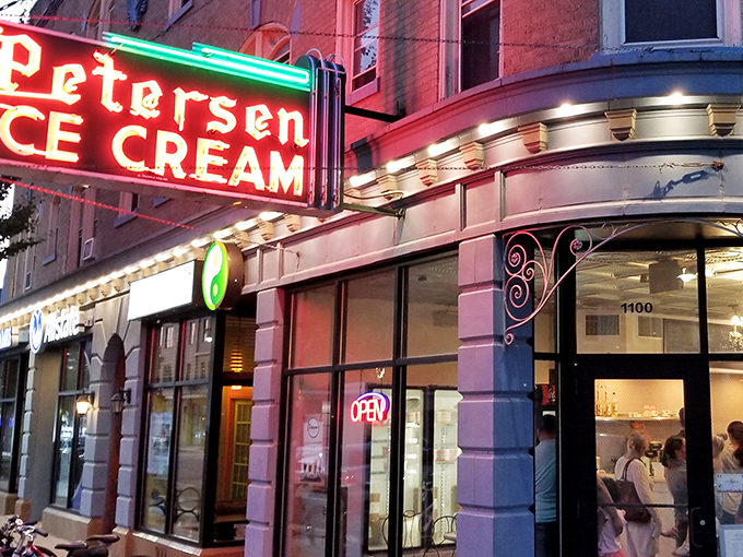 That neon sign doesn't just advertise ice cream—it's a beacon of hope on a tough day and a promise of something wonderful around that curved corner entrance.