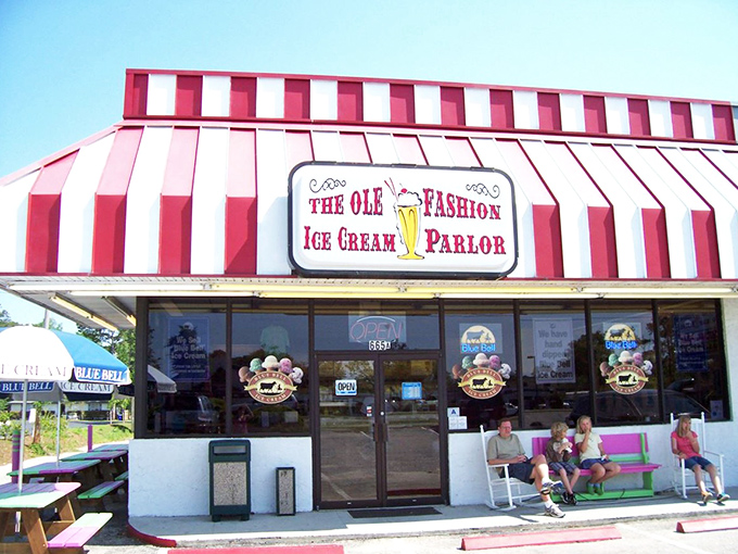 The red and white striped awning isn't just eye-catching—it's the universal signal that serious ice cream happiness awaits inside. No filter needed on this classic Americana.
