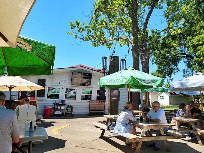 The charming cottage-like exterior of Grinders Stonewall beckons with its red-trimmed sign and helpful "ENTER OVER HERE" arrow—like your coolest friend's secret hideaway.
