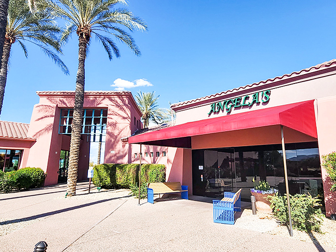 Angela's Kitchen welcomes you with its warm terracotta exterior and vibrant red awning—like a sunset-colored beacon for hungry souls in Surprise.