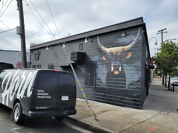 The unassuming exterior of Horn BBQ in Oakland – where that bold white lettering against dark panels is the architectural equivalent of a whisper about the best-kept secret in town.
