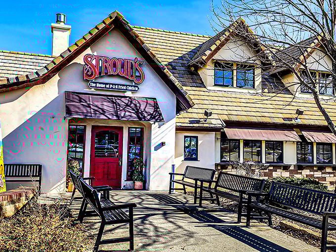 The red door at Stroud's stands like a portal to comfort food paradise, promising pan-fried delights beneath that charming pitched roof.