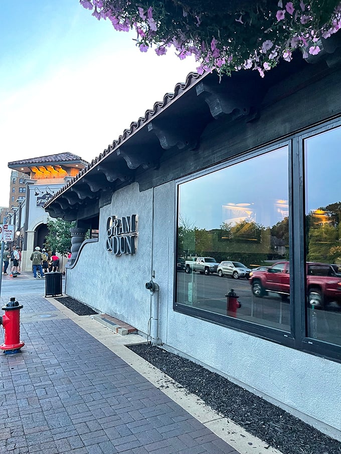The entrance to Gram & Dun beckons like an old friend with its warm brick façade and elegant signage—architectural foreplay for the culinary adventure that awaits inside.