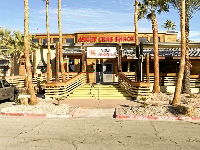 Palm trees and wooden ramps welcome you to seafood paradise—where the desert meets the ocean at Angry Crab Shack's inviting Henderson location.