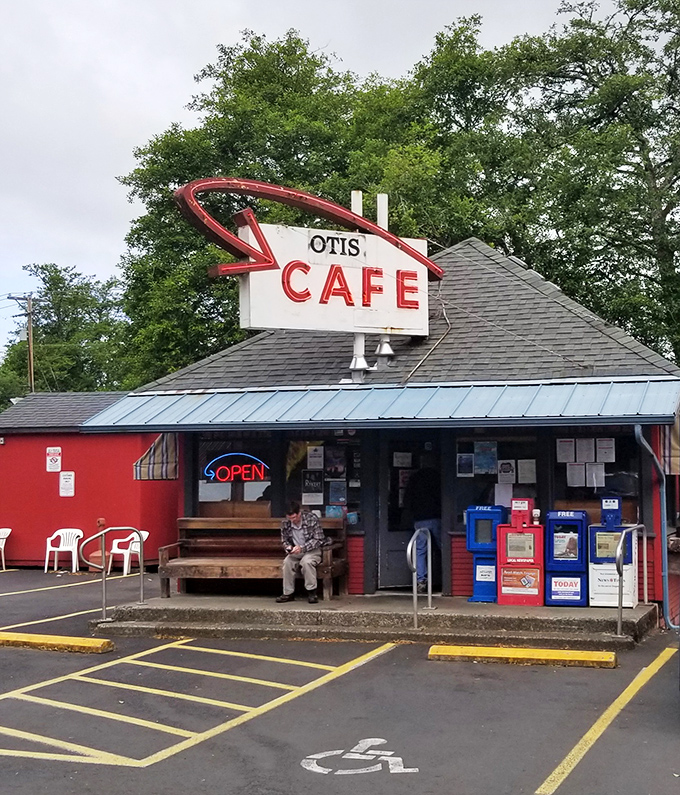 The iconic red exterior of Otis Café stands like a beacon for hungry travelers on Highway 18, promising comfort food salvation just minutes from the Oregon coast.