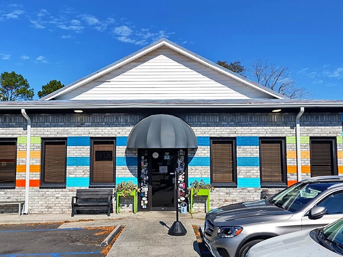 The colorful exterior of Early Bird Diner stands out like a beach umbrella in winter, promising a dining experience as vibrant as its paint job. 