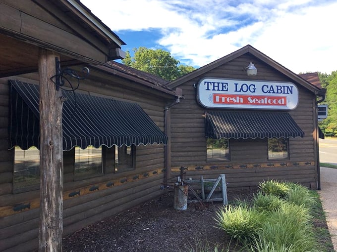 The rustic exterior of The Log Cabin isn't just charming—it's a promise that what awaits inside is authentic, unpretentious, and deliciously memorable.