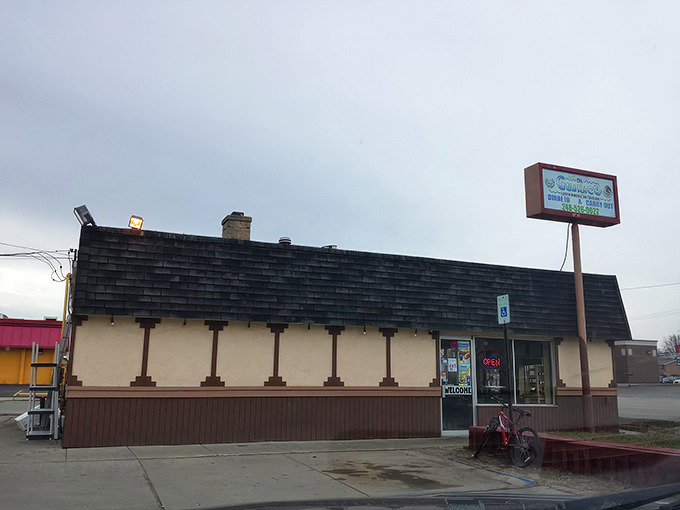 The unassuming exterior of El Guanaco might not stop traffic, but trust me—what happens inside this blue-trimmed building will stop your taste buds in their tracks.