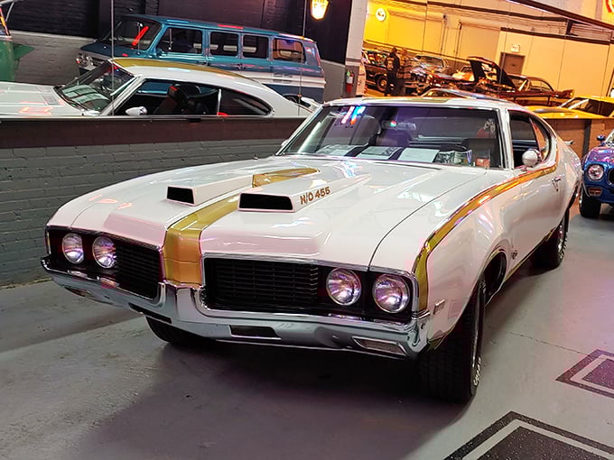 Muscle car perfection in white and gold. This Oldsmobile represents an era when American cars weren't just transportation—they were statements.